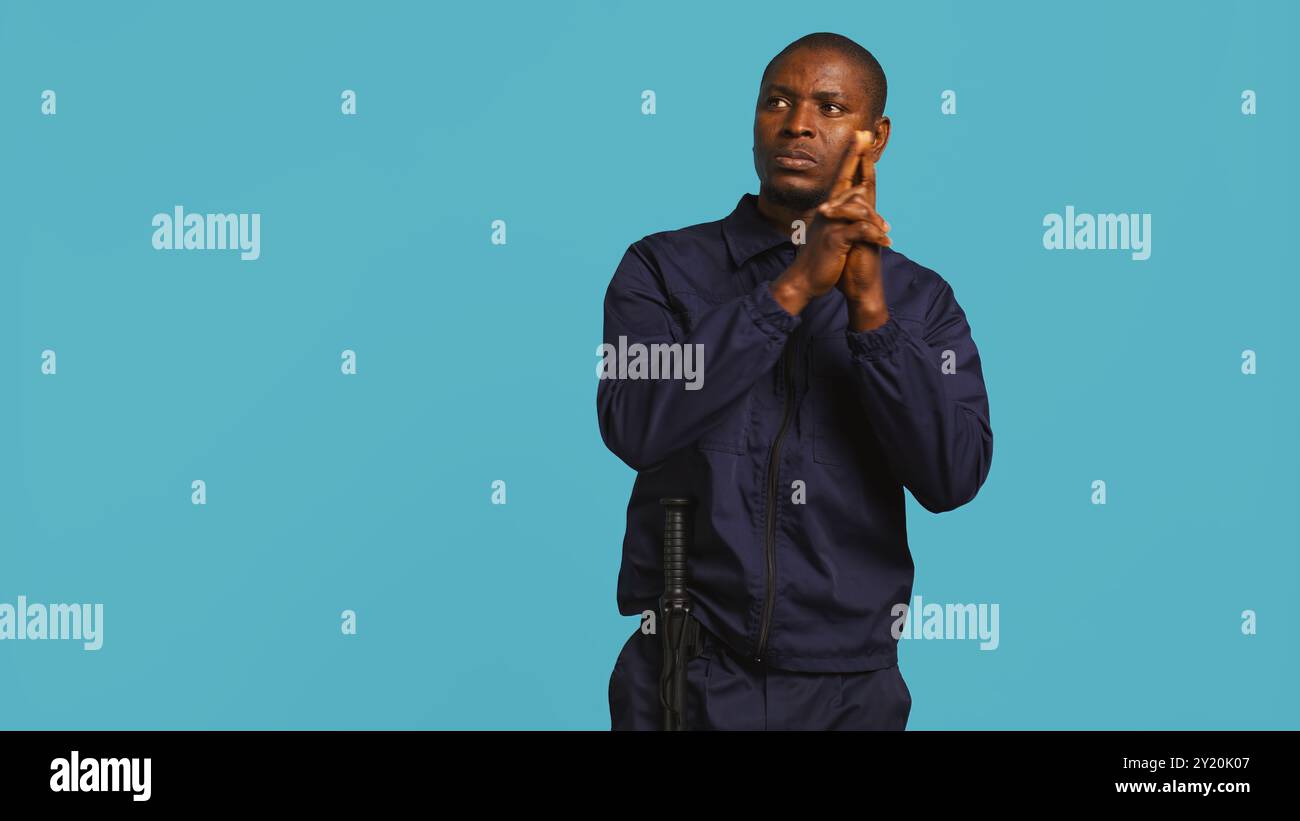 Security guard doing pretending to shoot gun hand gesture while being ...