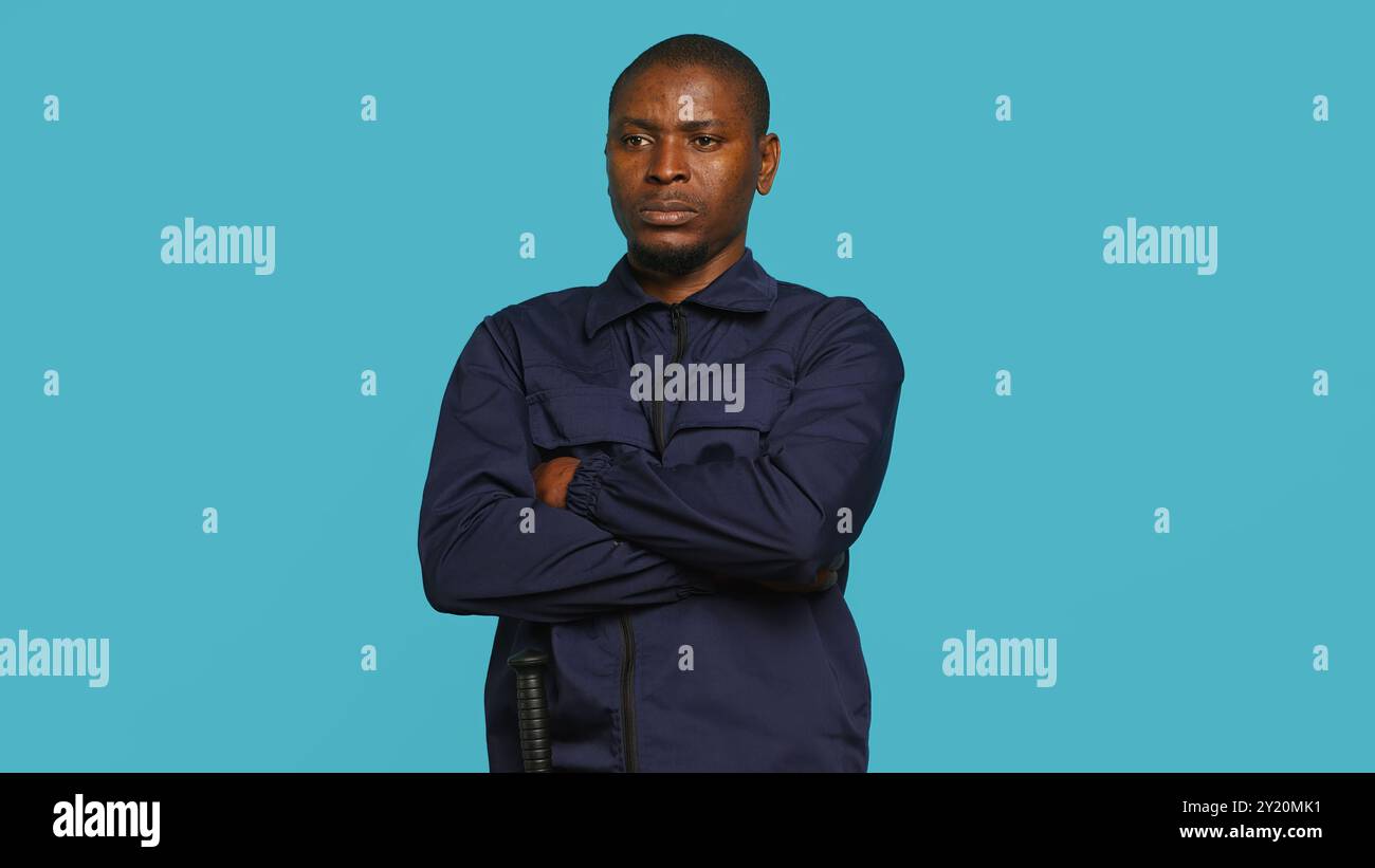 Security guard in threatening pose, tasked with preventing criminal ...