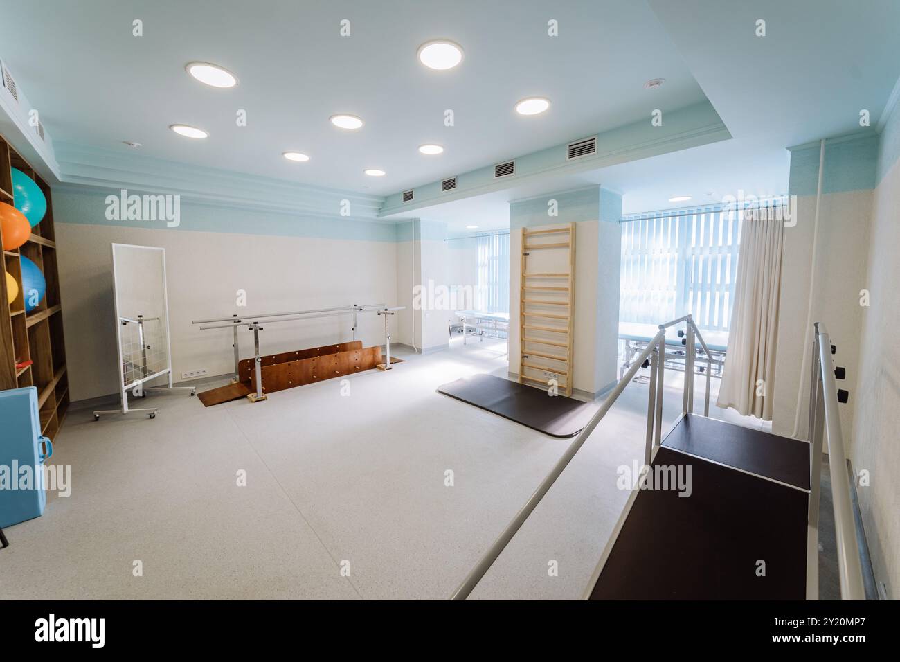 Rehabilitation room with parallel bars and equipment for physical ...