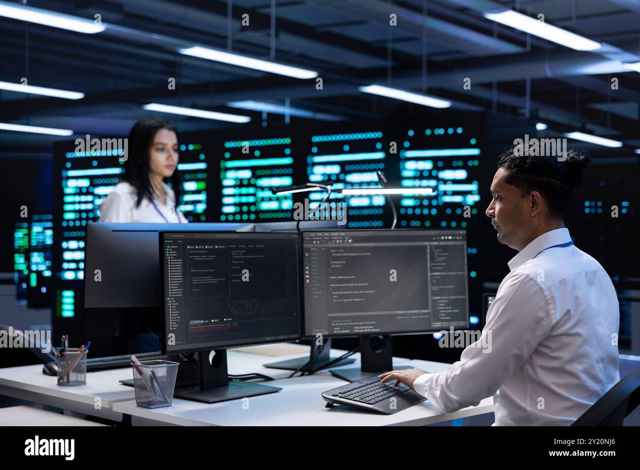 Coworkers In Data Center Using Computers To Find Firewall