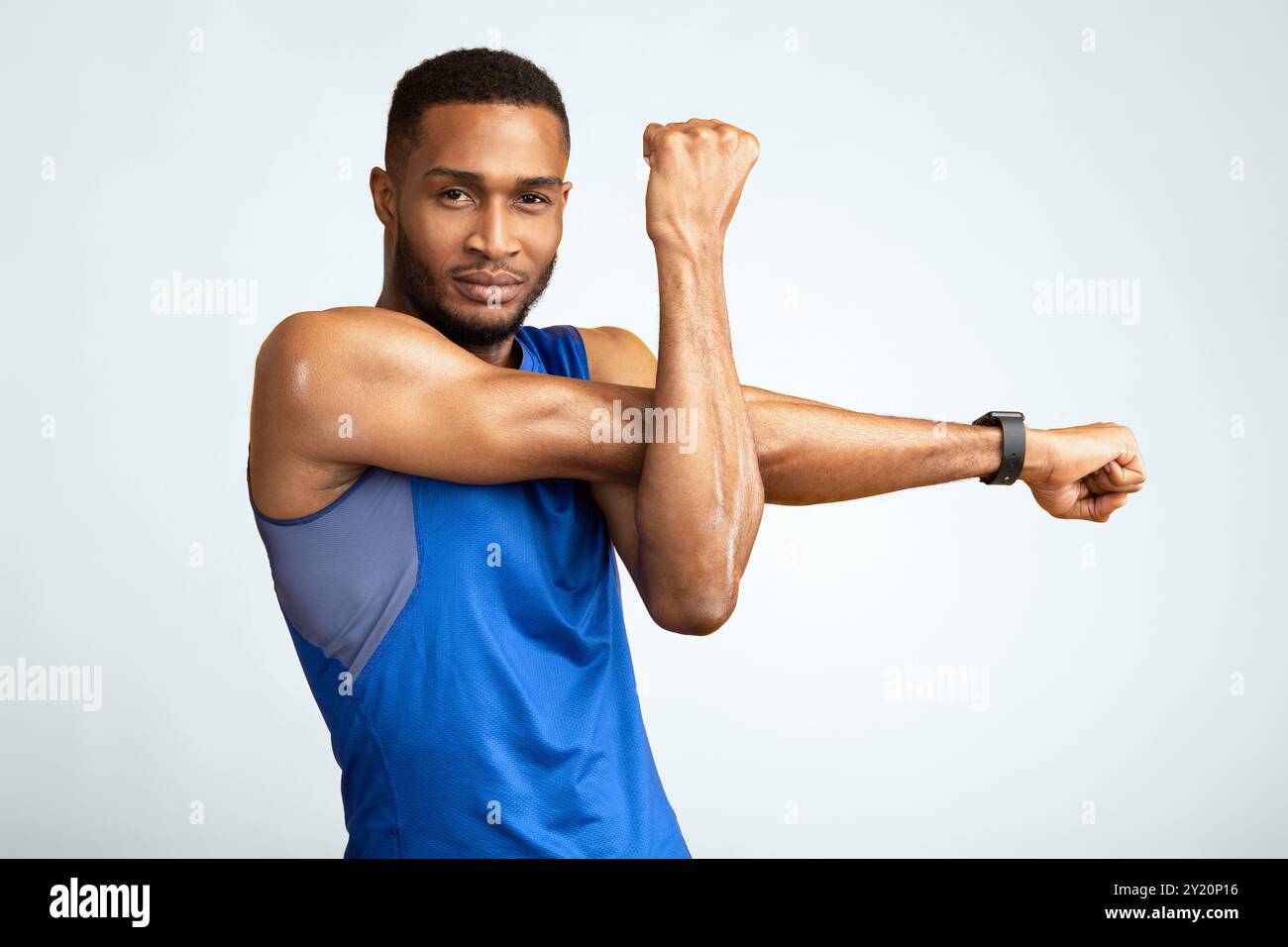 Healthy black guy stretching hand and shoulder before workout Stock ...