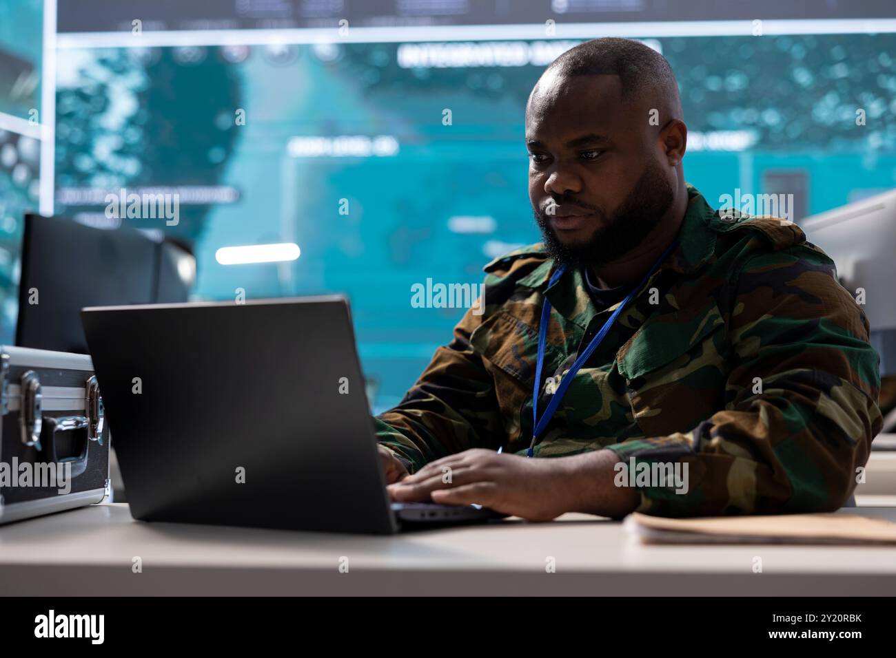 Army officer employs high tech computer in a control tower power base ...