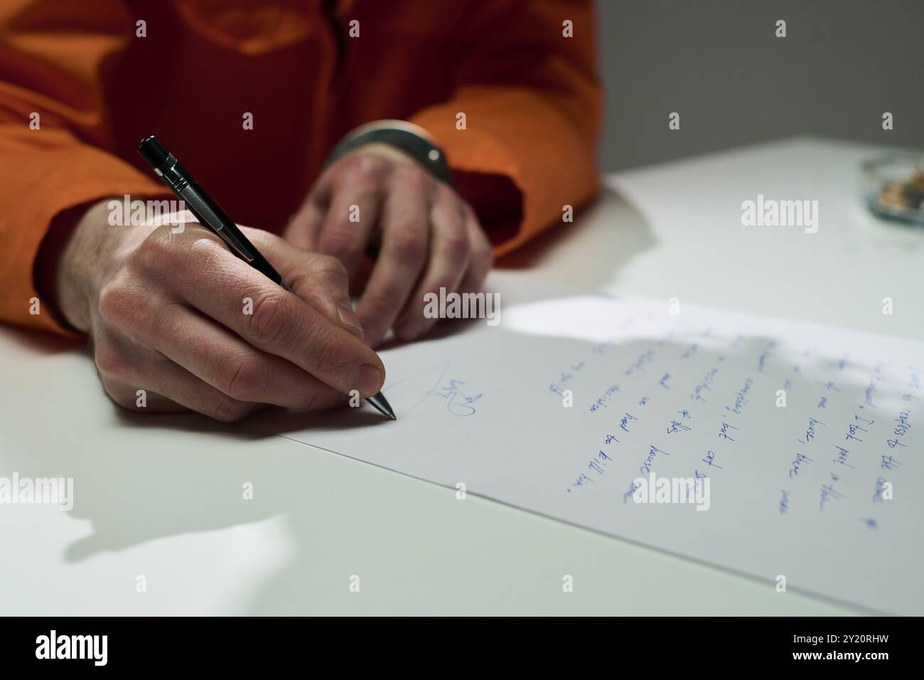 Hand holding pen and writing on paper, featuring content written in ...