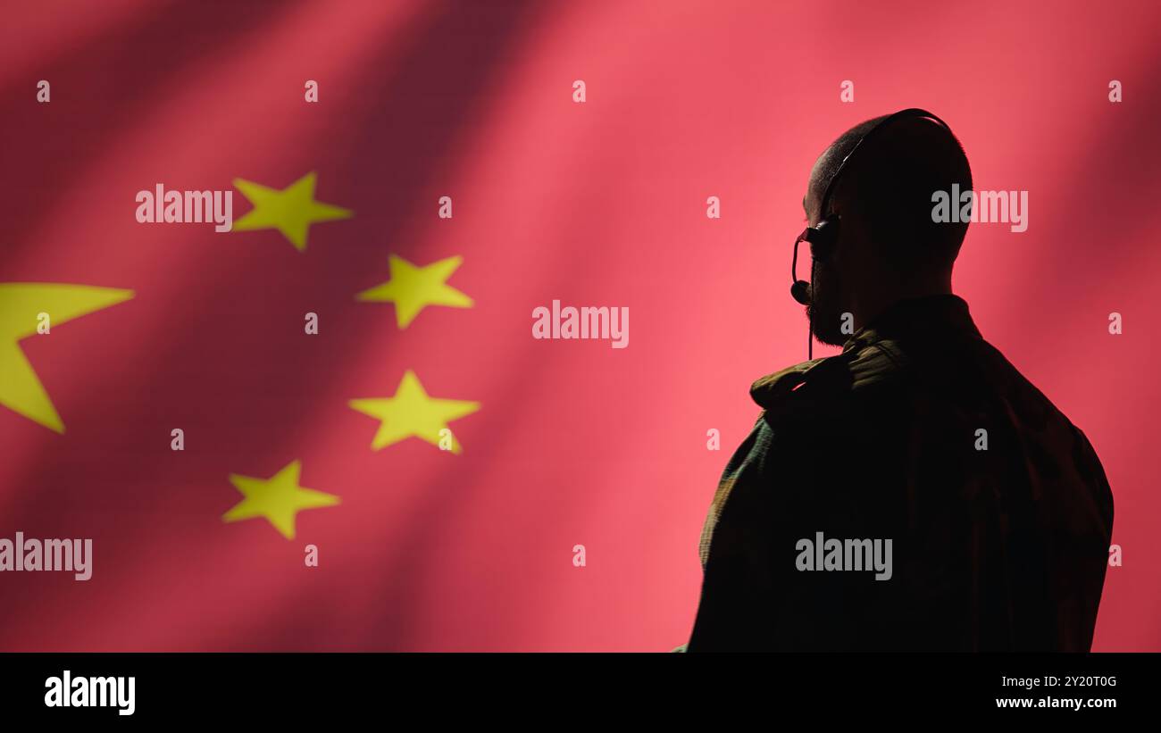 Military dispatcher working for Chinese army relaying info for troops using headset. Radio ...