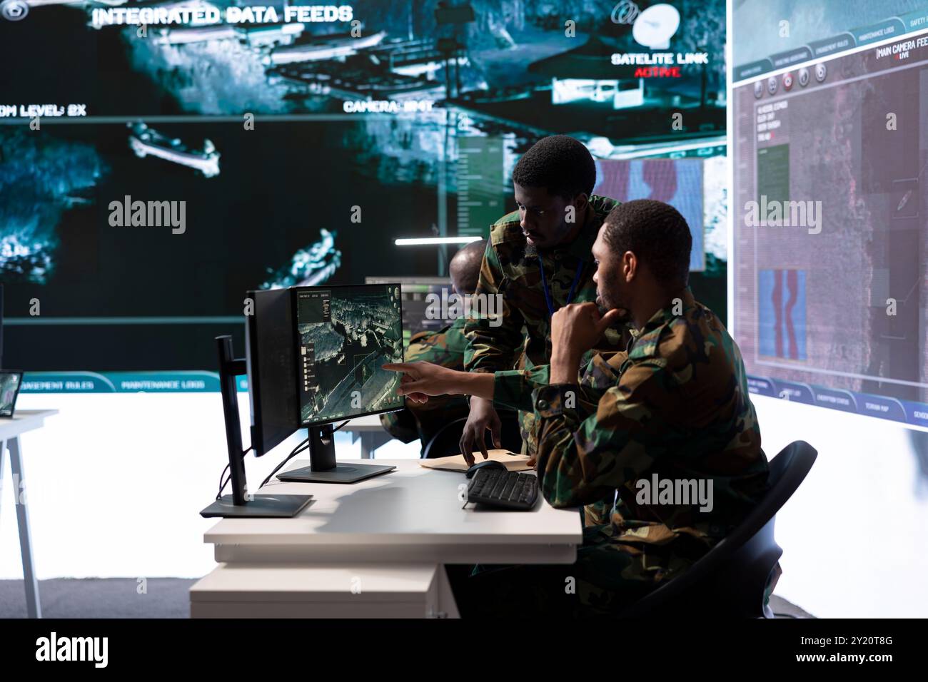 Team of military professionals in a control center monitors satellite ...