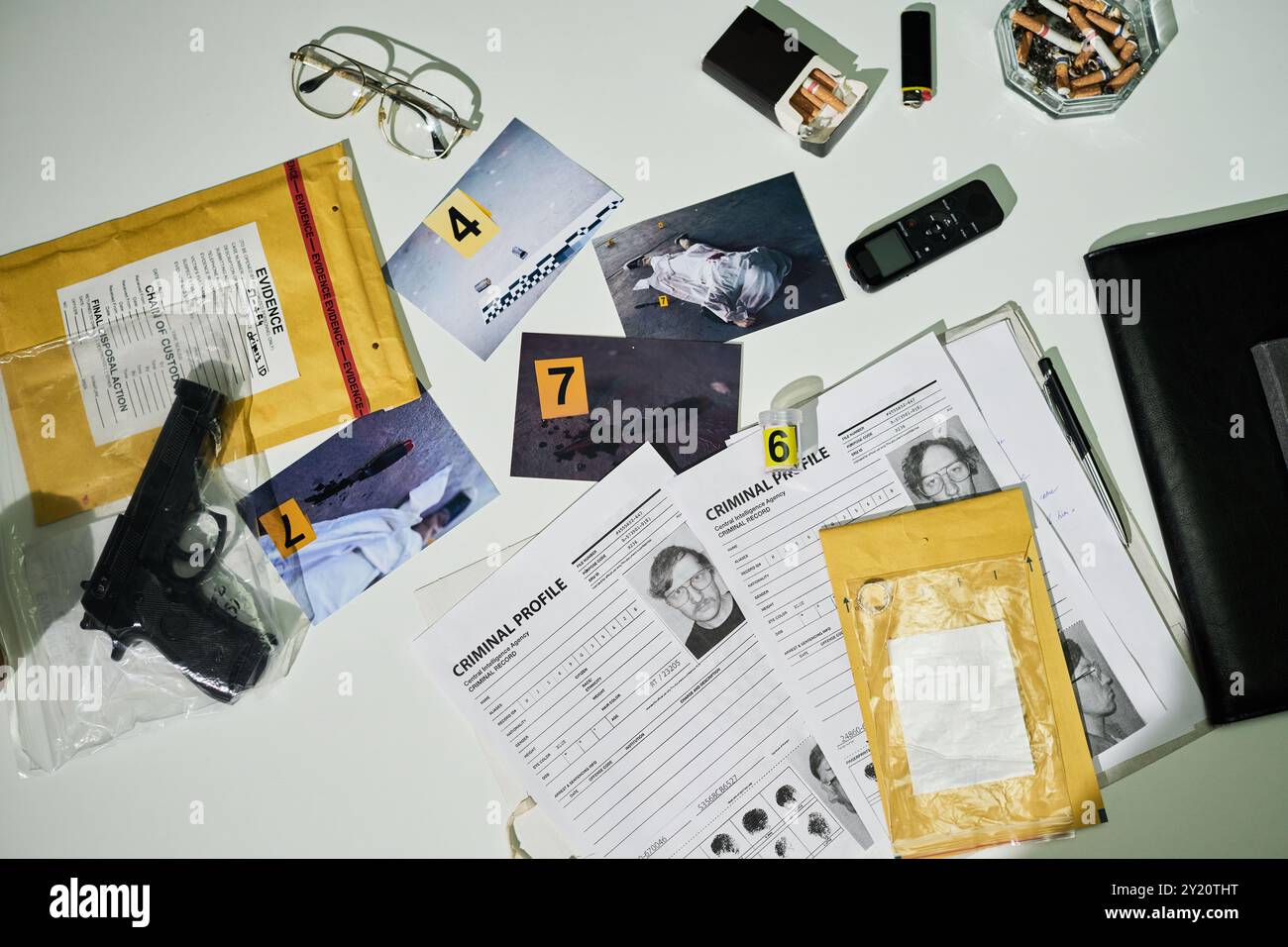 Collection of crime scene evidence on an office desk includes ...