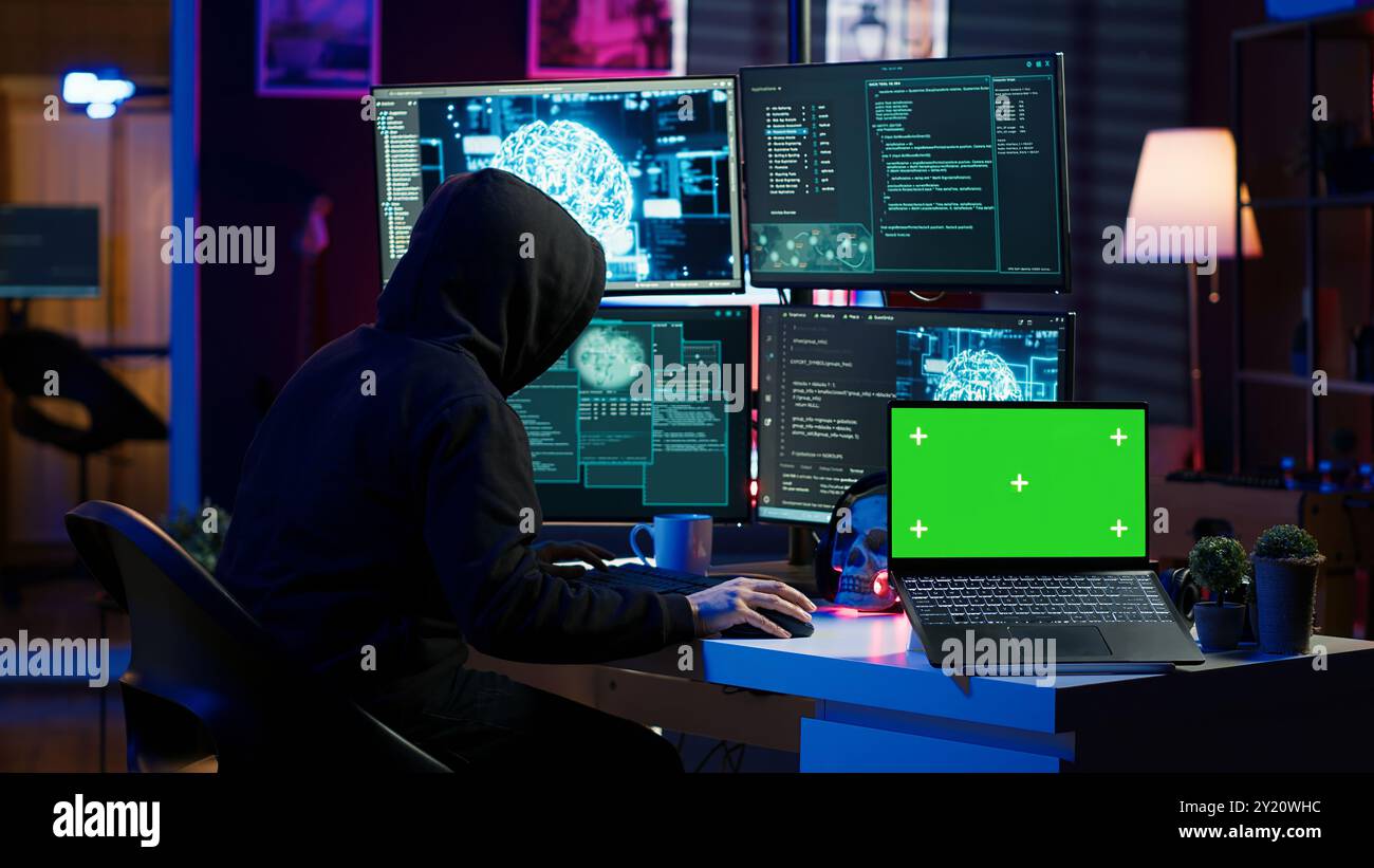Hacker in hidden place using green screen laptop to deploy malware on ...