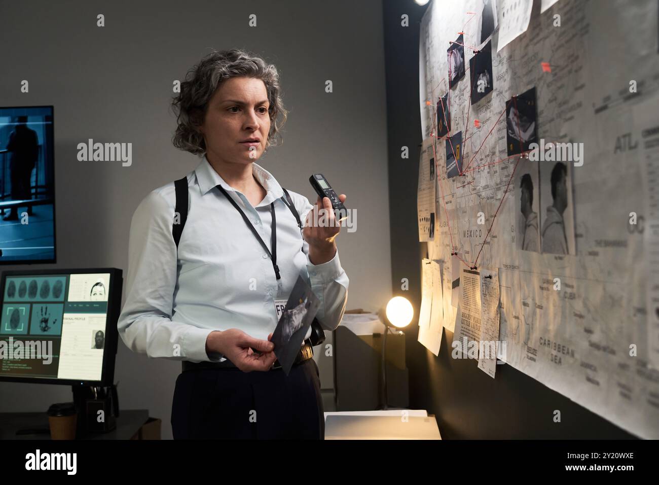 Woman Reviewing Crime Scene Photos and Analyzing Clues on Evidence ...