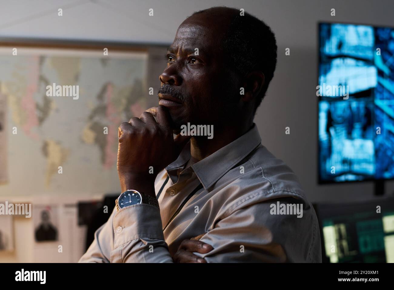Man thoughtfully analyzing data in modern office environment featuring ...