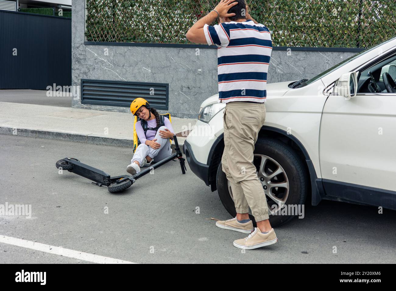 driver is shown holding their head in distress after hitting a Latin ...