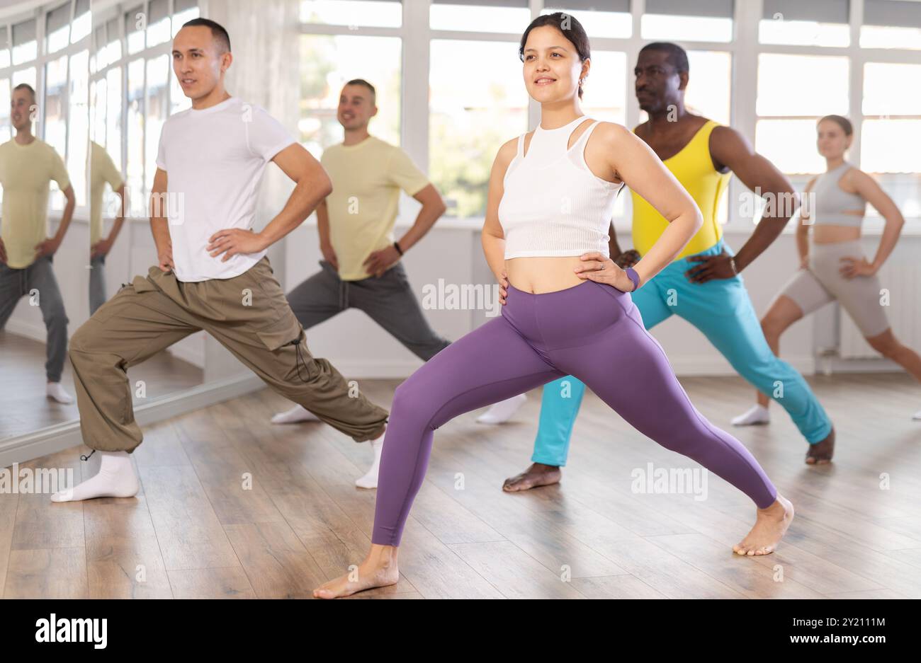 Group of people warming up before dance class Stock Photo - Alamy