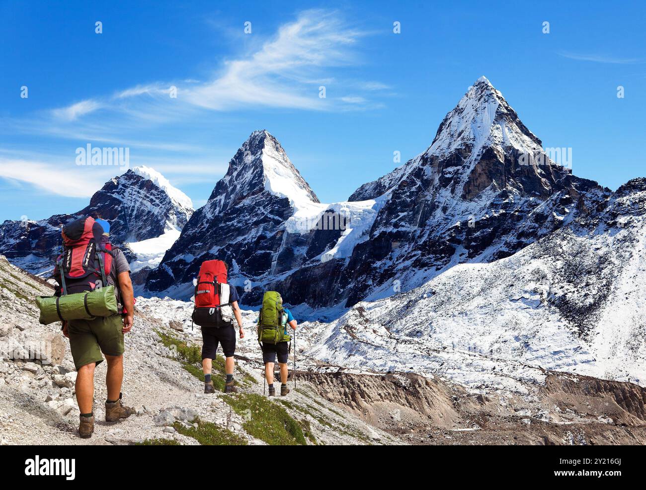 three hikers climbers trekkers mountaineers, way to Mt Everest base ...