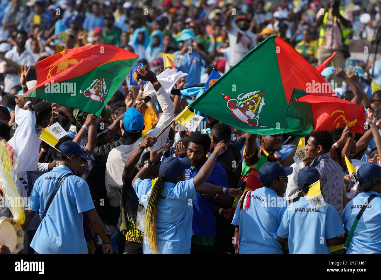 Attendees wave flags of Papua New Guinea East Sepik province during a ...