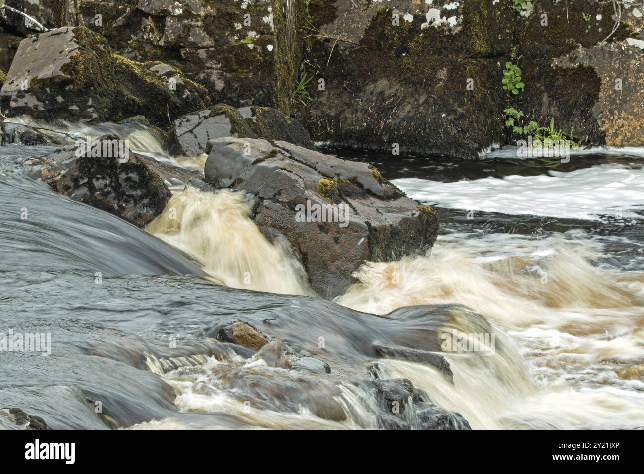 Fast-flowing peat-water river on The Isle of Skye, Scotland, United ...