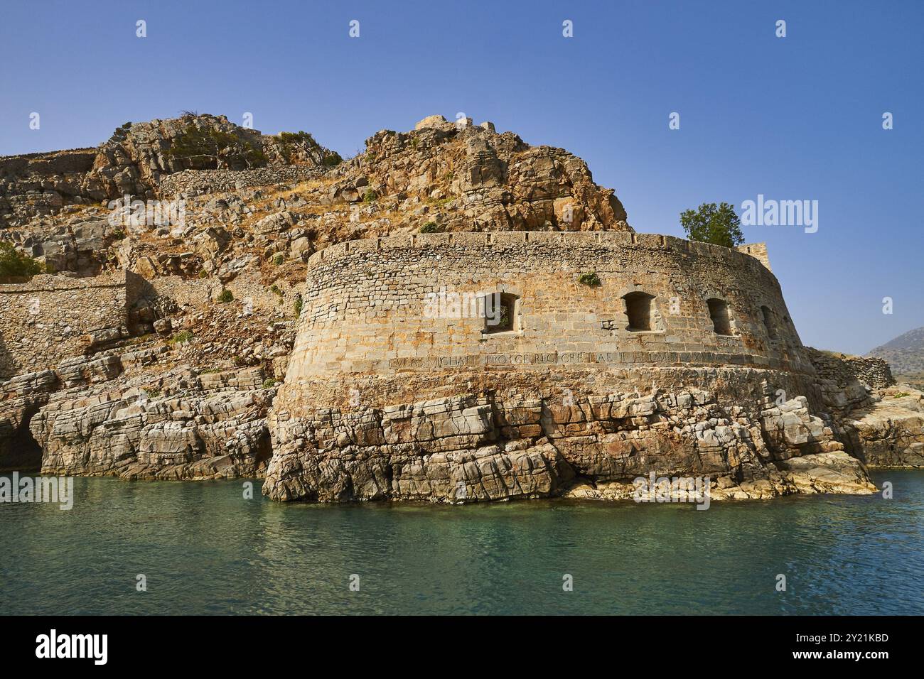 Ruins of an ancient fortress on a coastal rock formation with clear sky ...