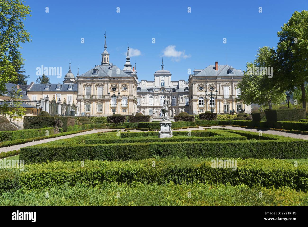 Baroque palace with manicured hedges and sculptures against a clear blue sky, Royal Castle La ...