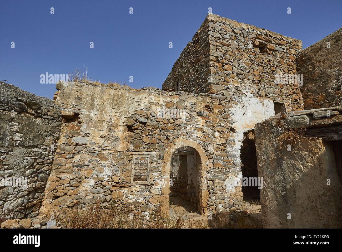 Abandoned stone houses and ruins under a clear blue sky on a sunny day ...