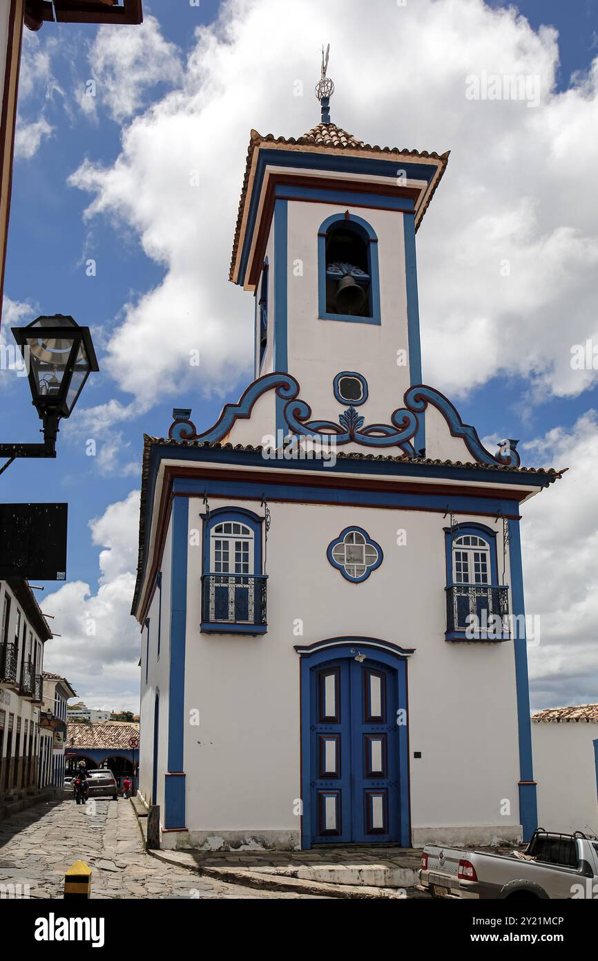 Front view to small beautiful chapel in white and blue against blue sky ...