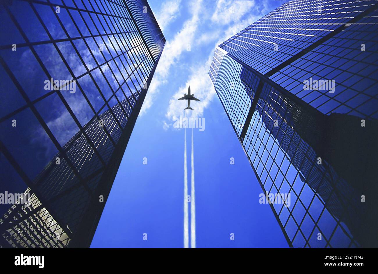 Airplane over skyscrapers Stock Photo - Alamy
