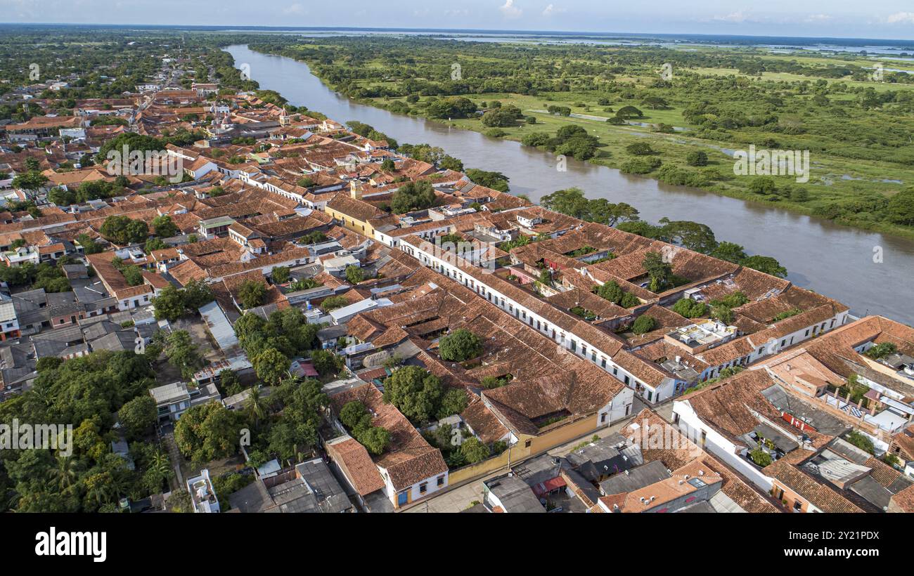 Aerial view of the historic town Santa Cruz de Mompox in sunlight with river and green ...