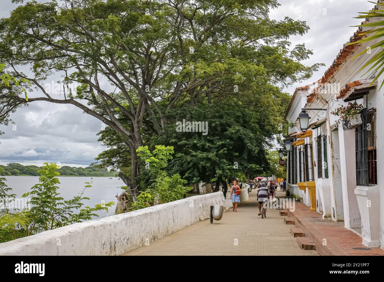 River promenade with typical historic houses, trees and river, Santa ...