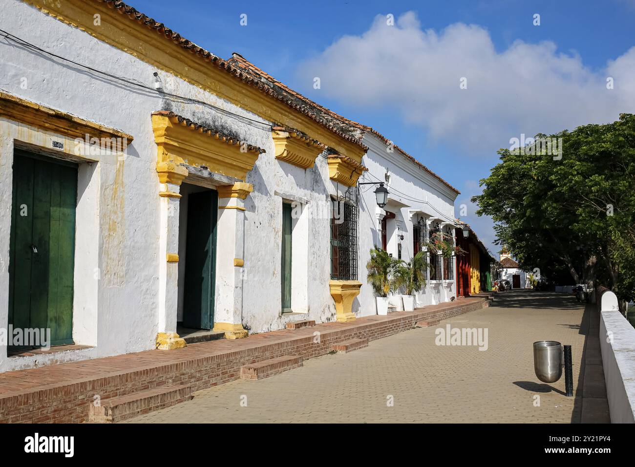 Typical historic houses in warm afternoon light, trees and river, Santa Cruz de Mompox, Colombia ...