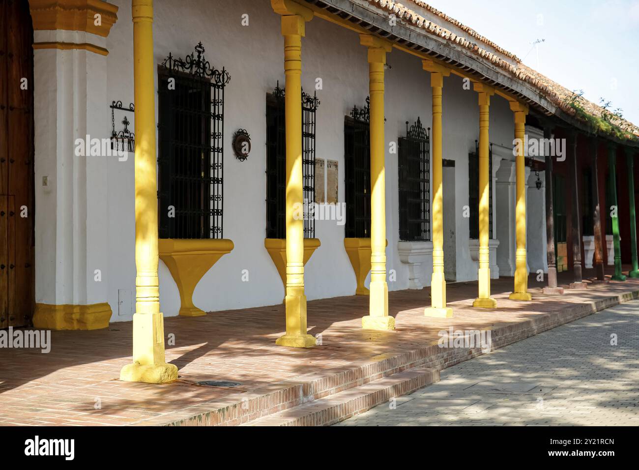 Traditional one story house with wooden yellow columns in warm ...