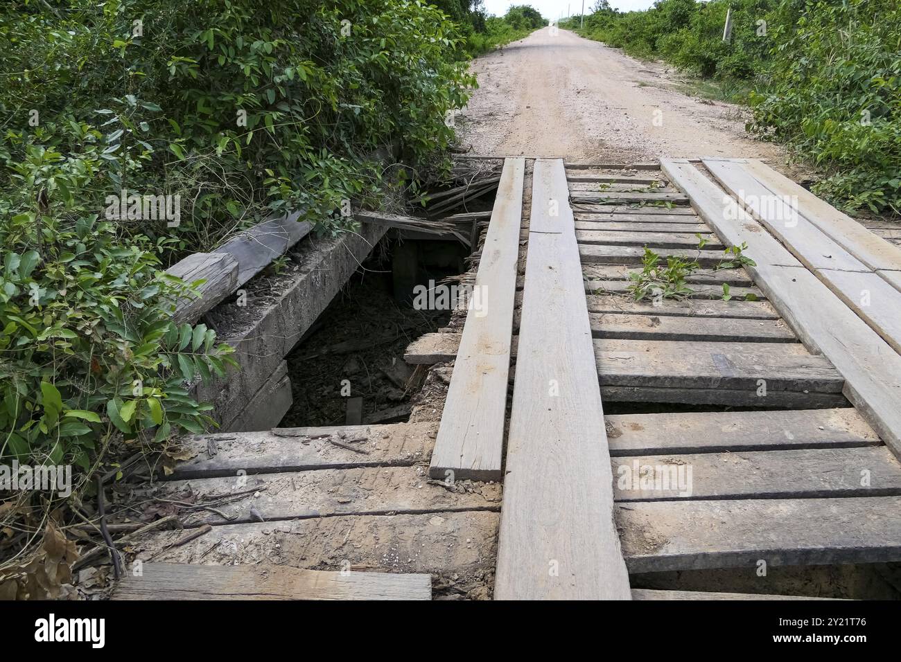 Close-up of a run-down wooden bridge with big holes of the ...