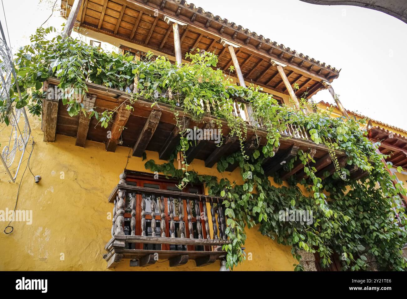 Low angel view of a traditional building with wooden balcony and green ...