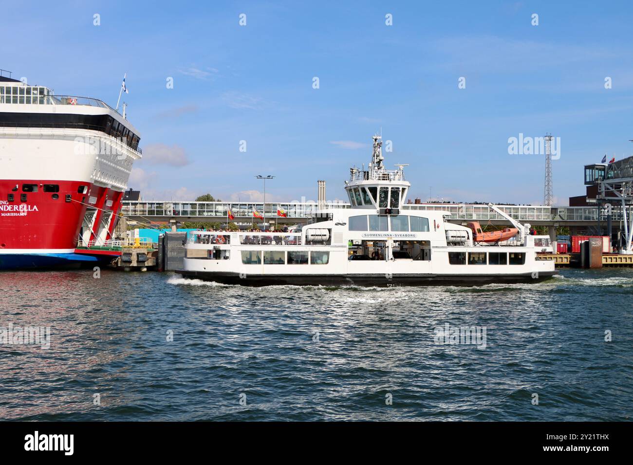 Suomenlinna ferry boat passing Viking Line Cinderella docked at ...