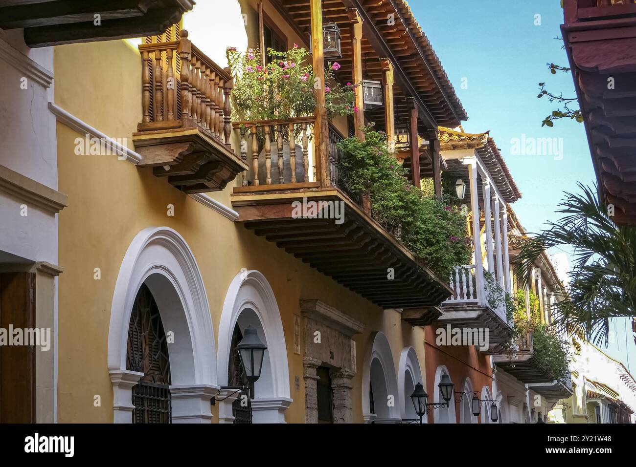 View to artful wooden balconies of historic houses in a narrow street ...