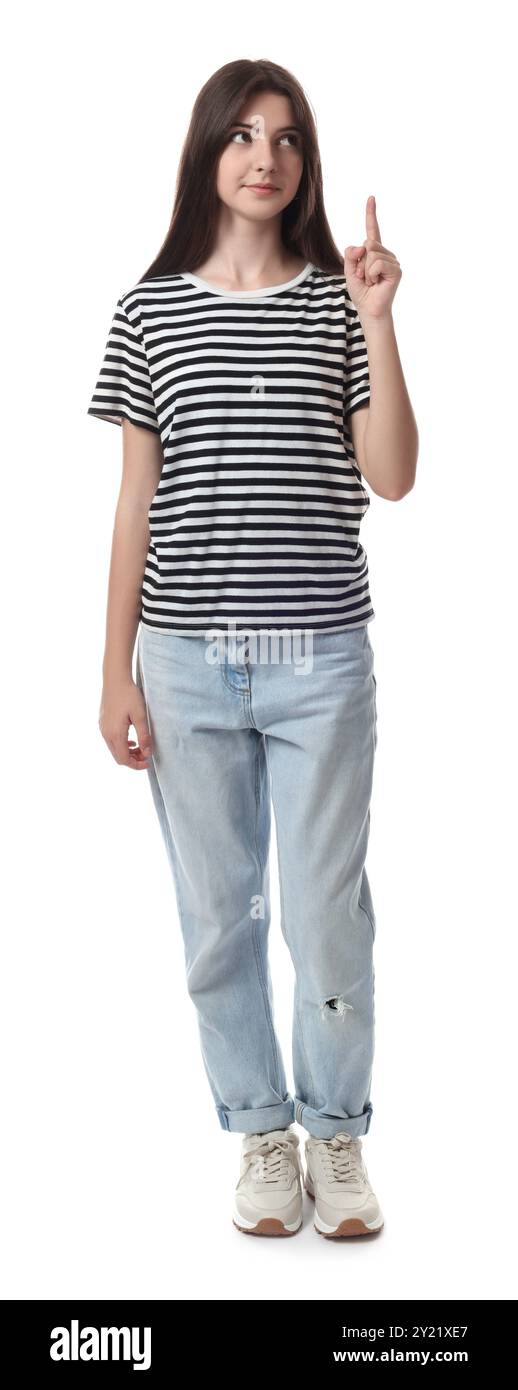 Cute teenage girl pointing at something on white background Stock Photo ...