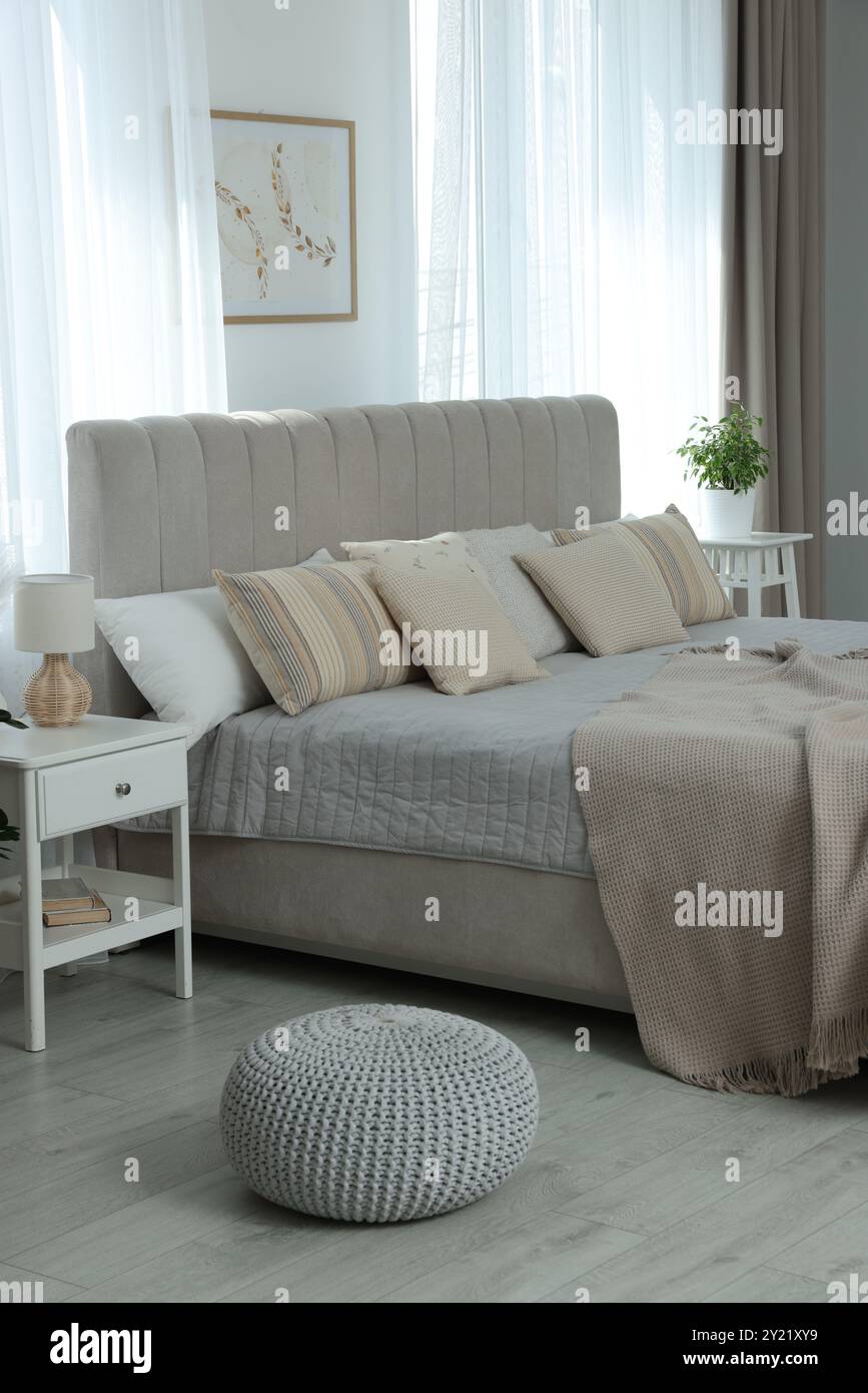Big comfortable bed in room. Interior design Stock Photo - Alamy