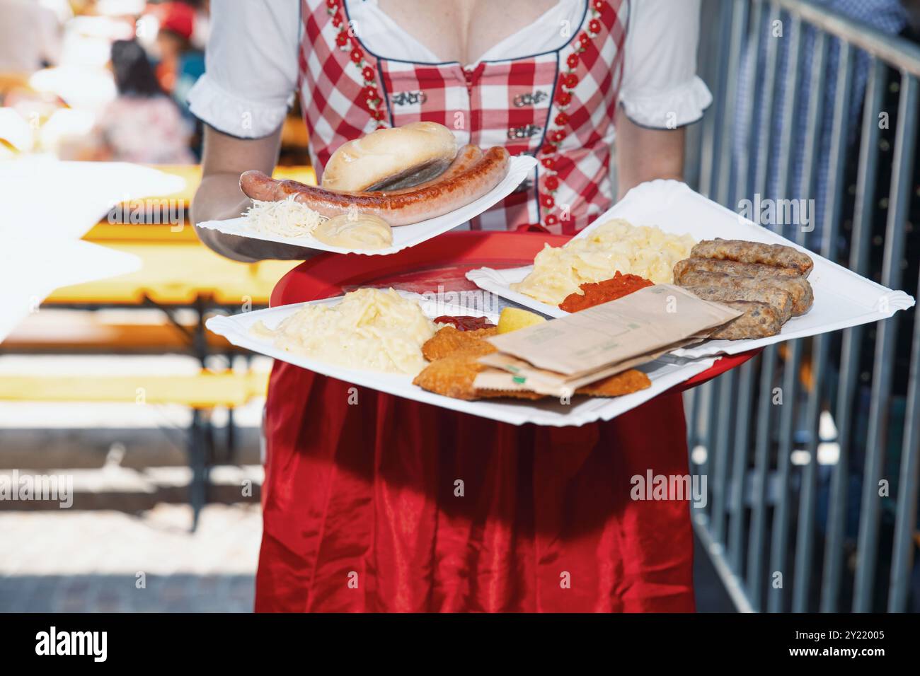In traditional costume, waitress serving variety of authentic German ...