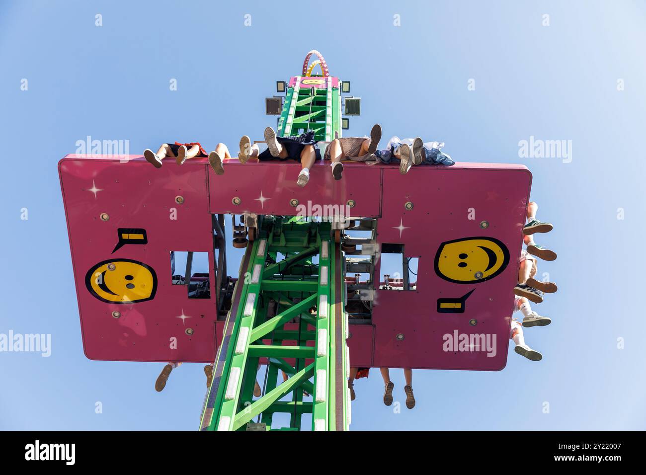 Exciting amusement park attraction with delighted expressions, feet ...