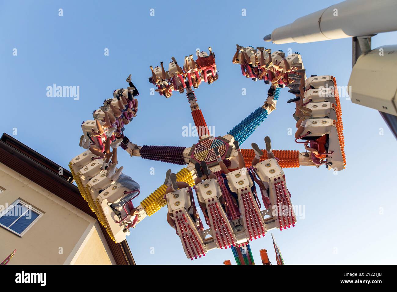 Colorful seats, twirling amusement ride, passengers enjoying, carnival ...