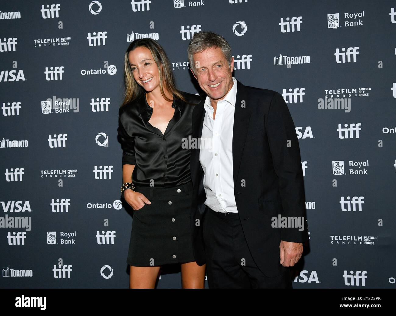 Hugh Grant, right, and wife Anna Elisabet Eberstein attend the "Heretic ...