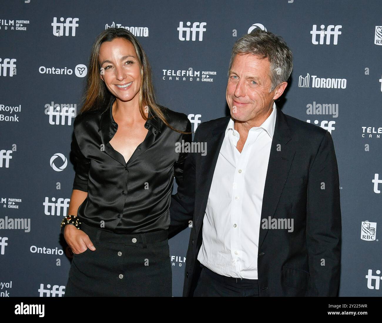 Hugh Grant, right, and wife Anna Elisabet Eberstein attend the "Heretic ...