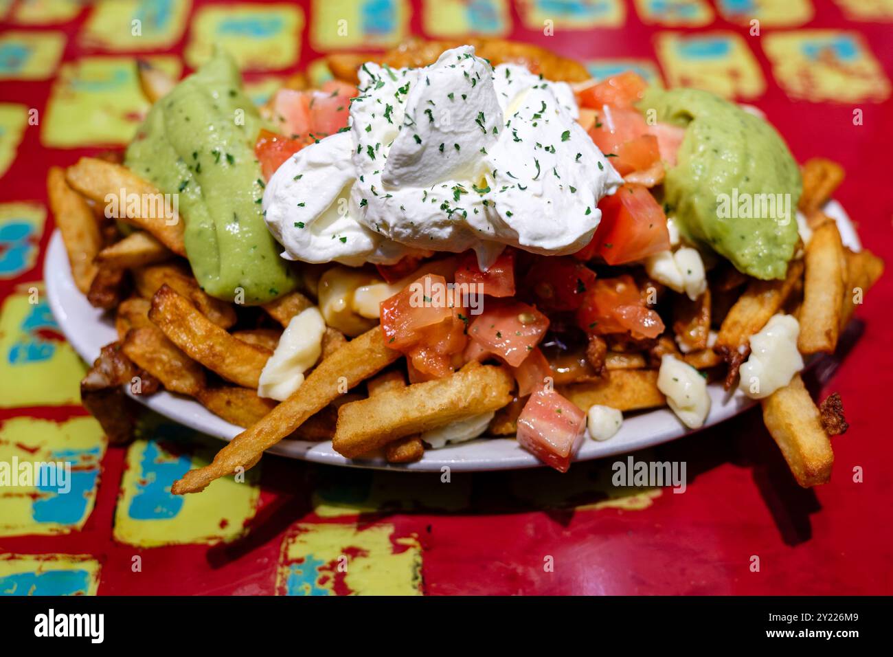 Vegetarian poutine dish with french fries, cheese curds, and brown ...