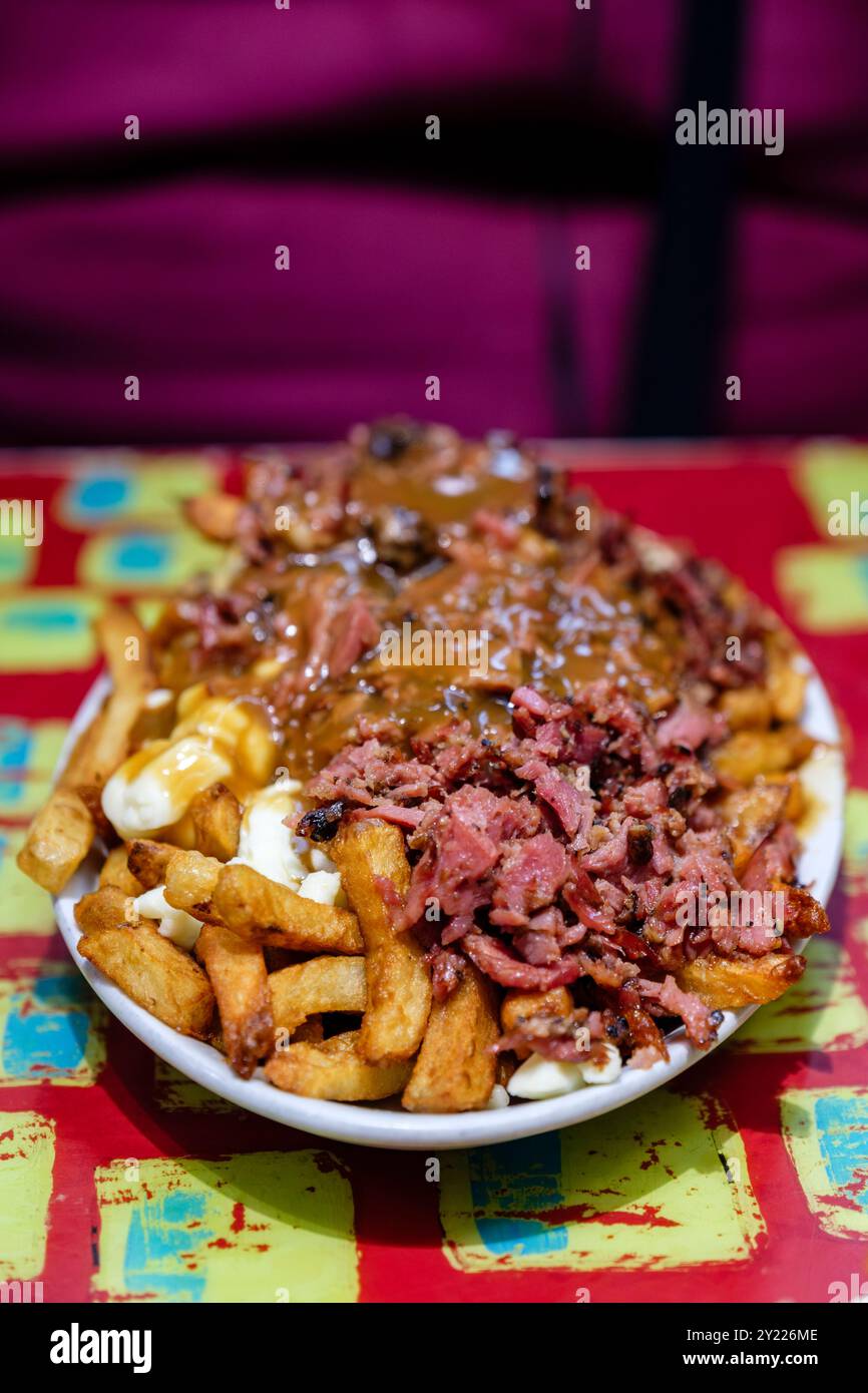 Montreal meat poutine dish served with french fries, cheese curds, and ...