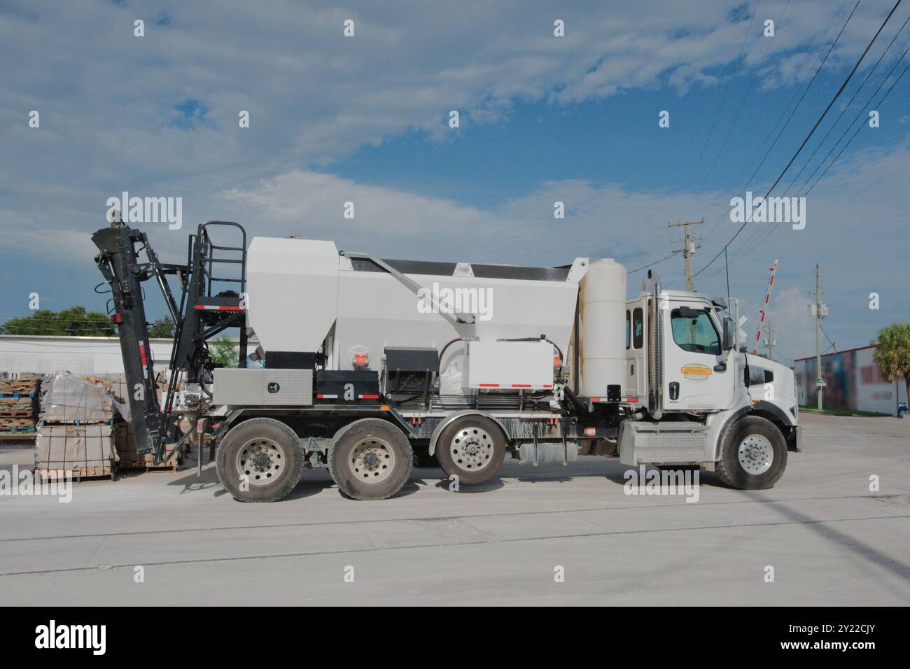 Side view of a large white cement truck late afternoon with blue sky ...