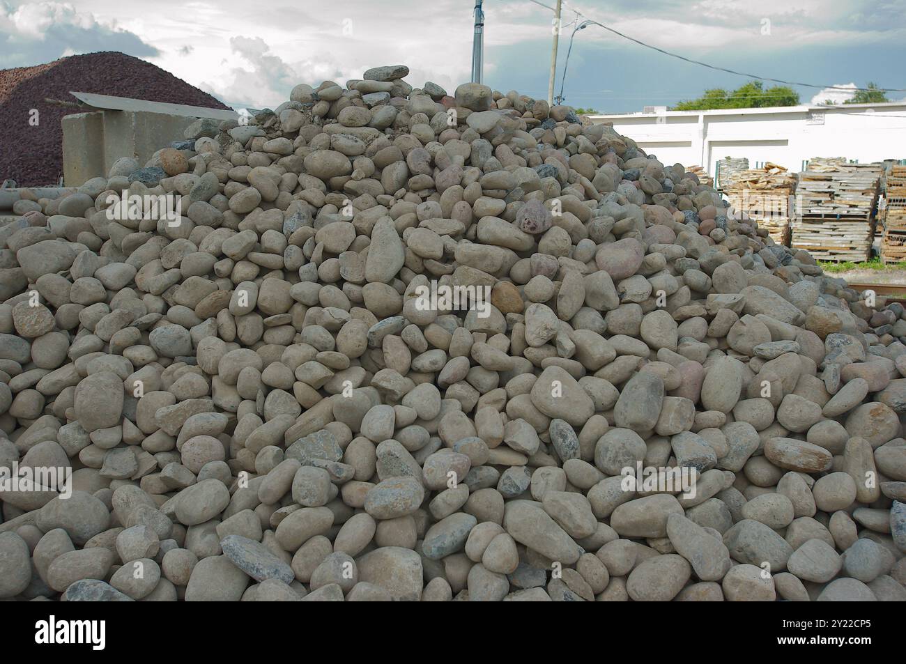 Wide view of a large pile of rocks up to blue sky and white clouds in ...