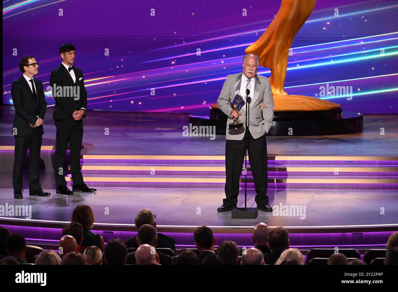 Gary Baum, right, accepts the Emmy for outstanding cinematography for a ...
