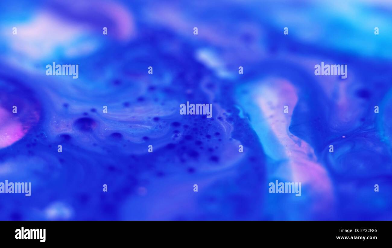Bubble fluid. Wet foam. Defocused neon blue pink color glitter oil ...