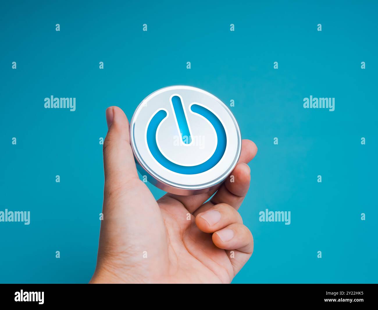 Power on, icon on chrome button or metallic badge in businessman hand ...
