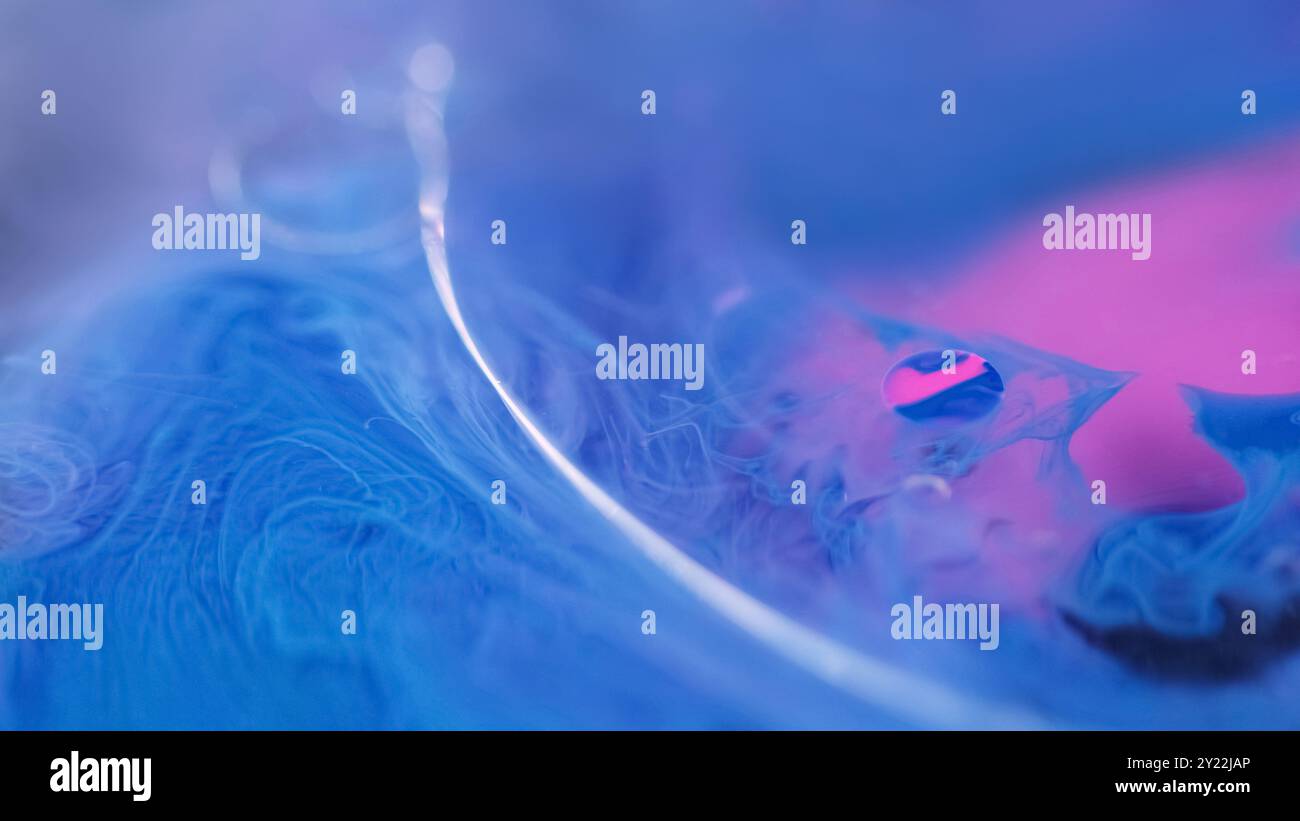 Neon paint. Magic smoke. Defocused blue pink color spilling holographic ...