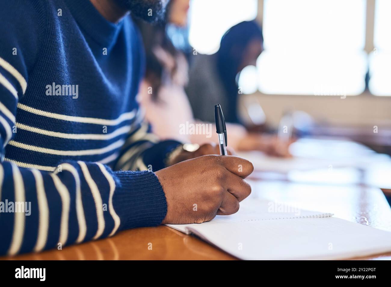 Hands, writing and notes in classroom at university for problem solving ...