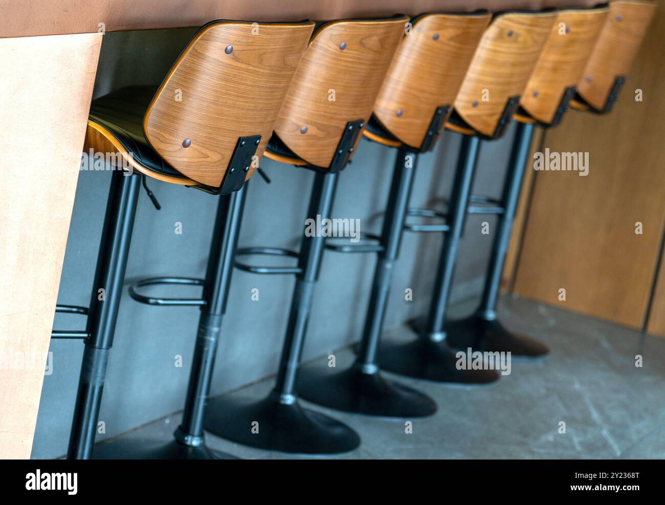 Arranged Brown Pub Bar Chairs with Black Metal Legs Stock Photo - Alamy