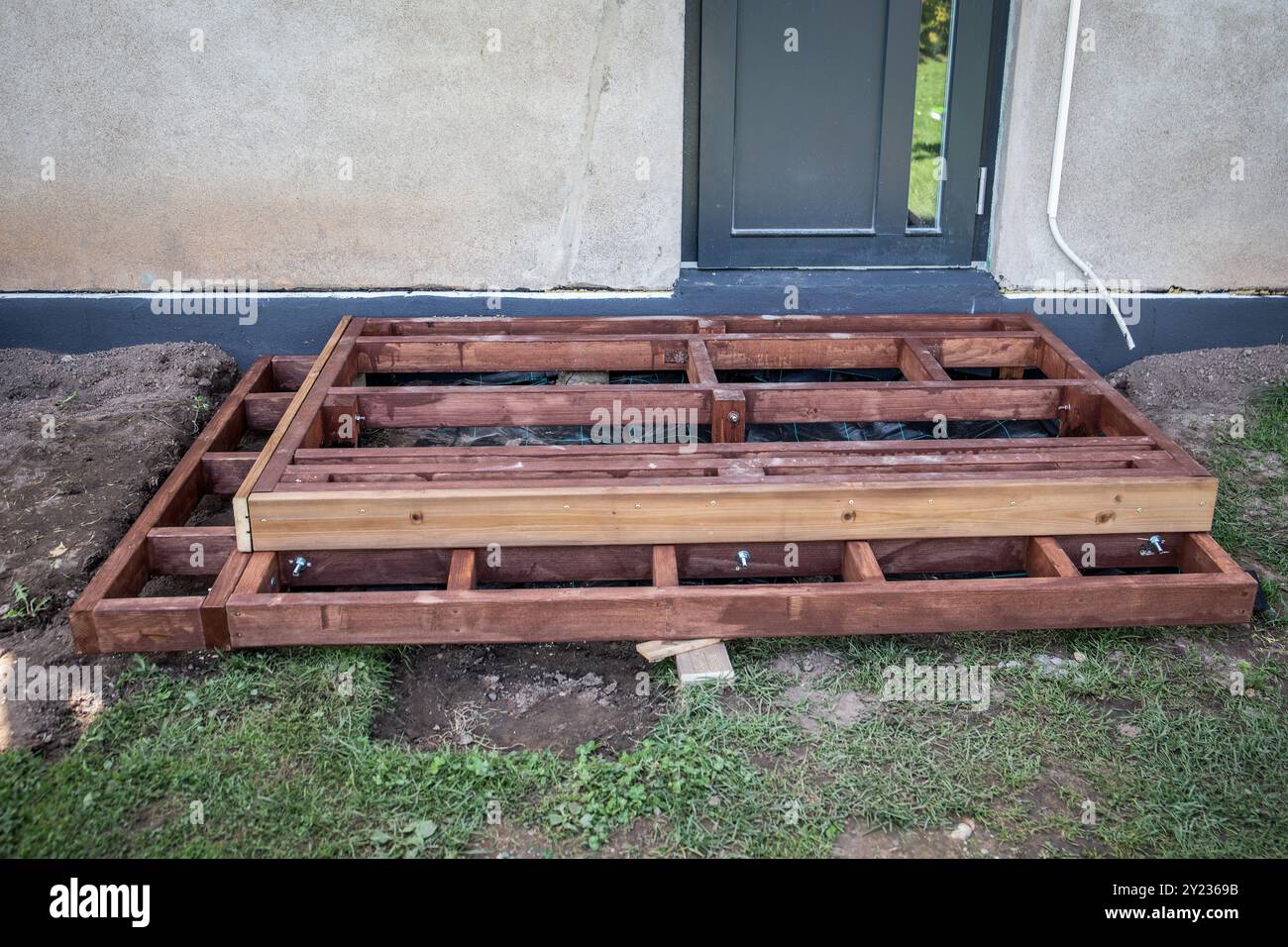 Construction of a terrace at the door of the house from wooden boards ...