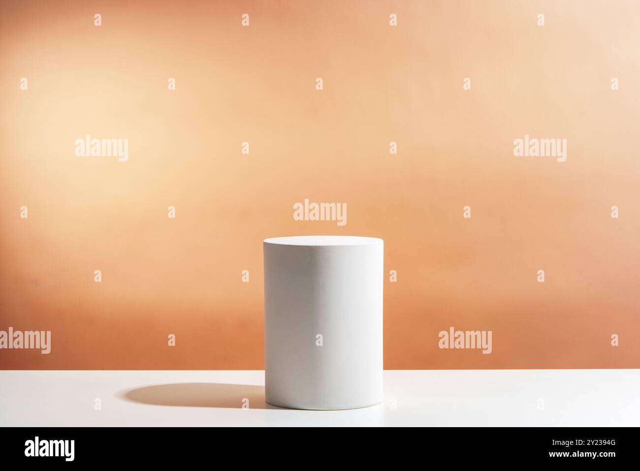 Minimalistic display of a white cylindrical object against a soft ...
